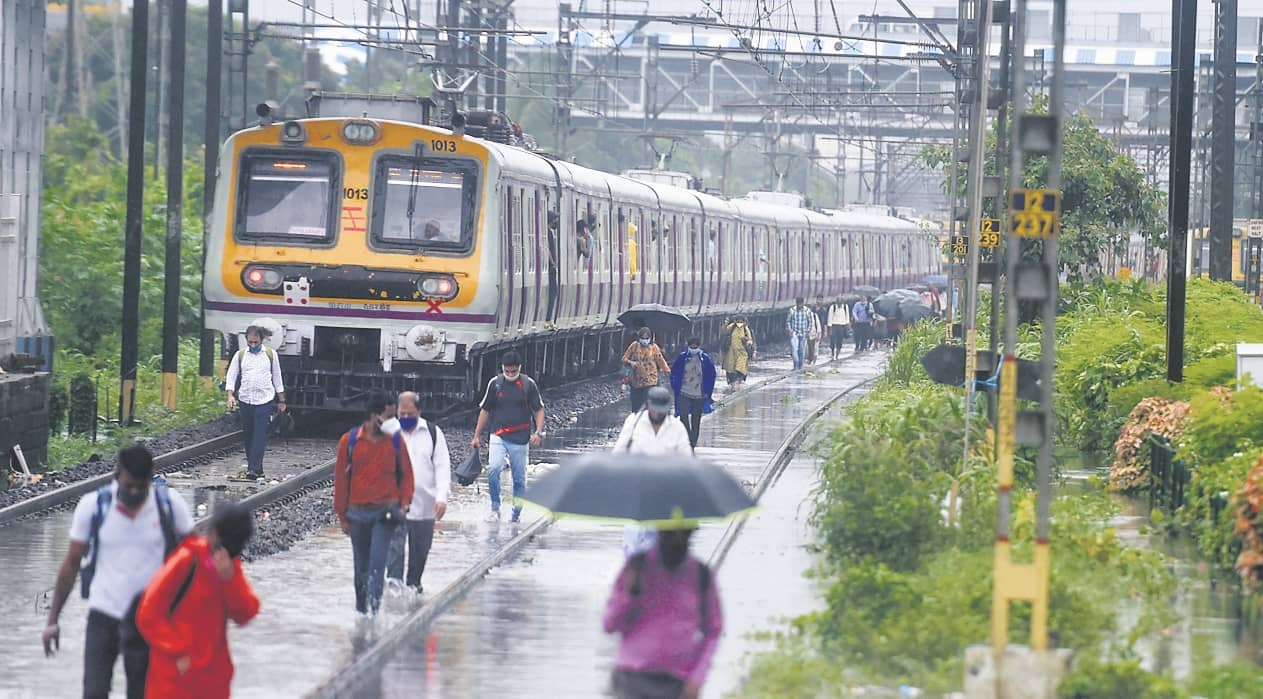 Slum evacuated, train services halted as heavy rain causes flood in ...